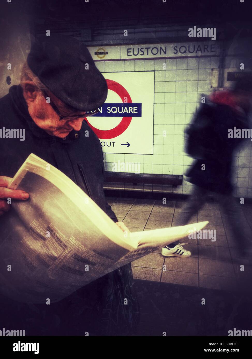 Man on subway train newspaper hi-res stock photography and images - Alamy