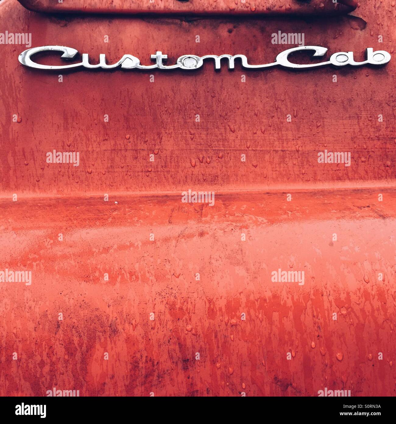 Chrome letters Custom Can on red car side Stock Photo - Alamy