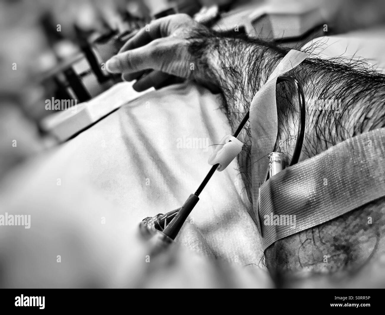 Blood infusion with canular. Arm reaching out. In high contrast black ...