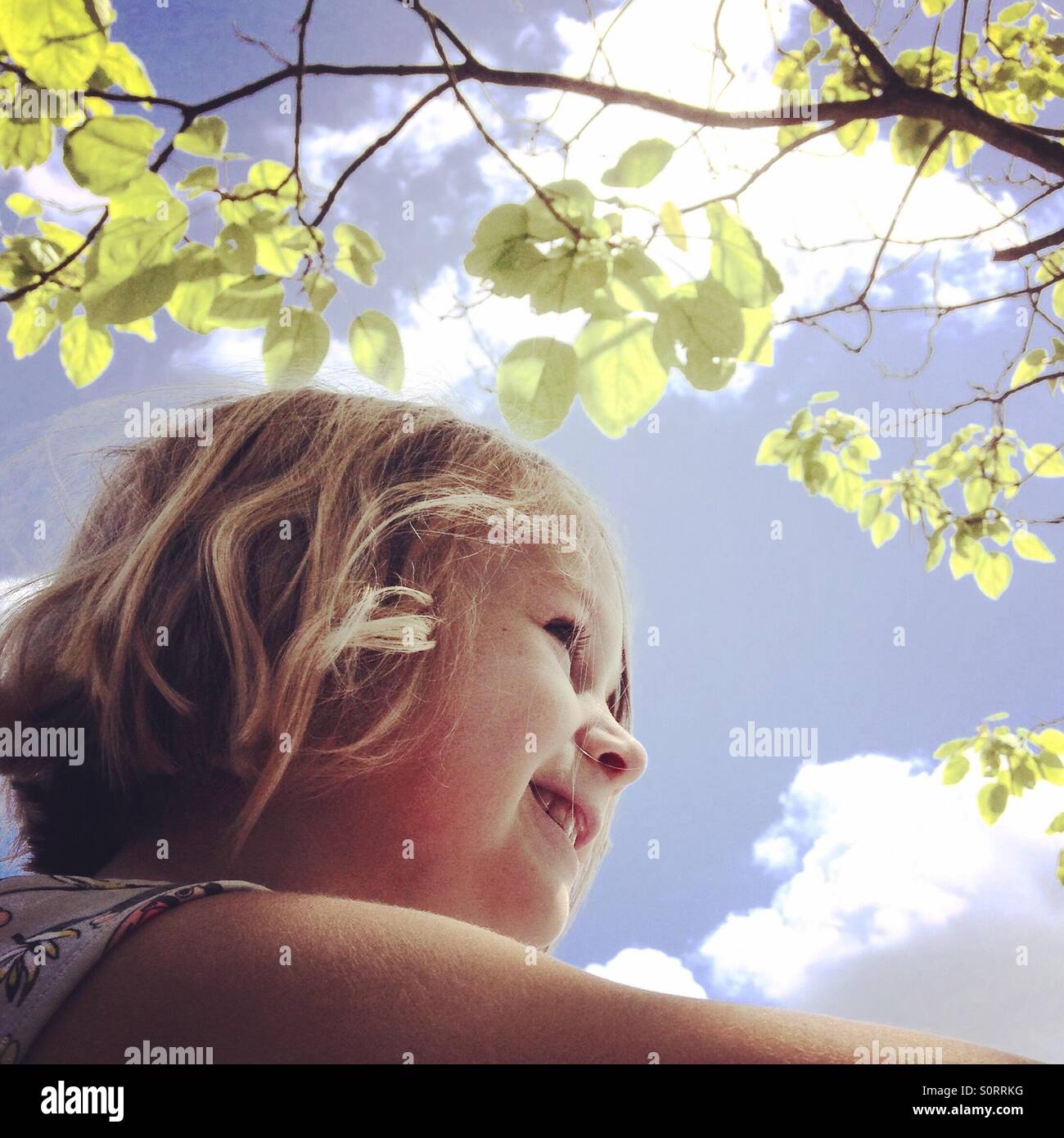 Girl looking and smiling away from camera Stock Photo - Alamy