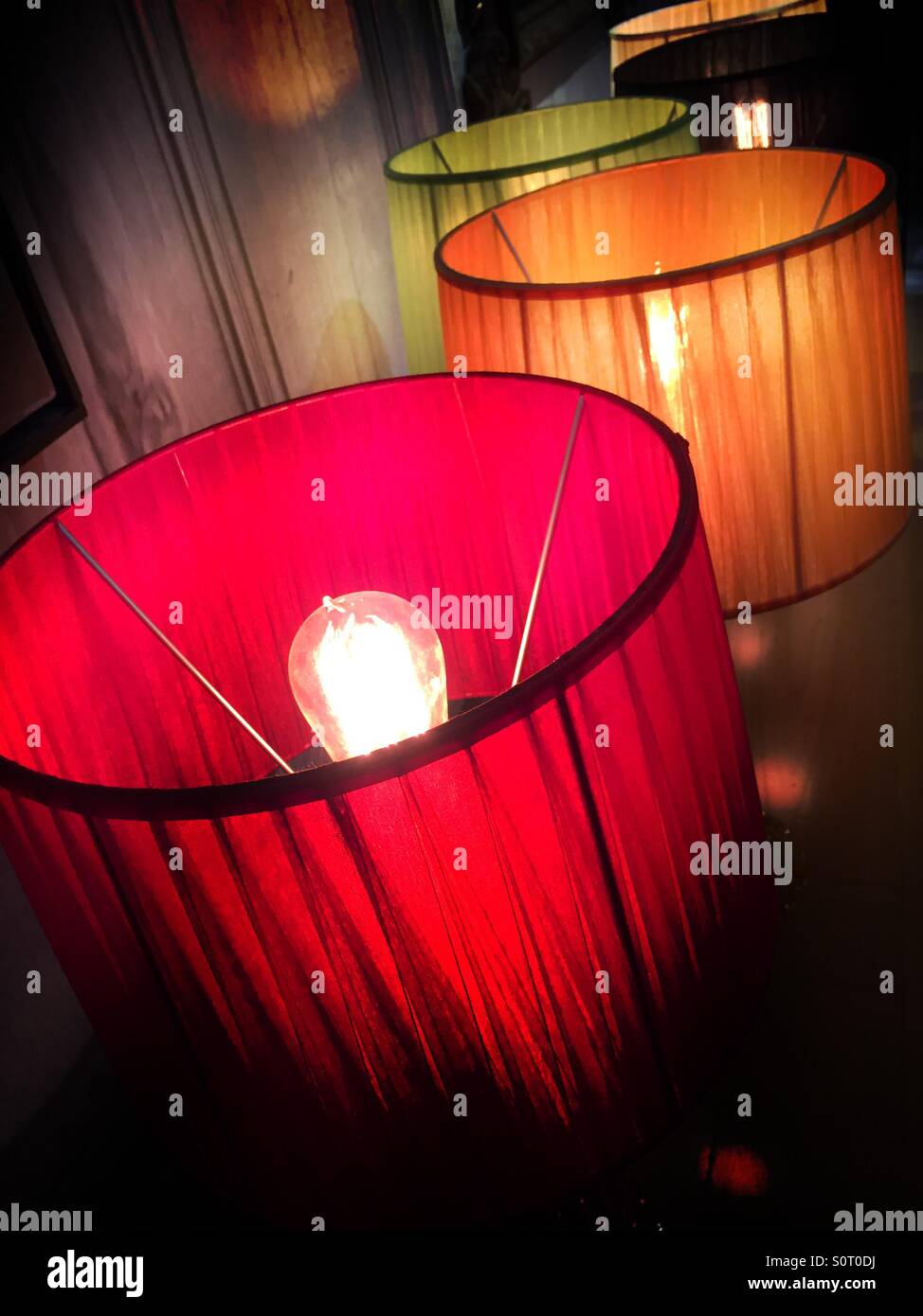 Lamps with red and orange lamp shades Stock Photo - Alamy