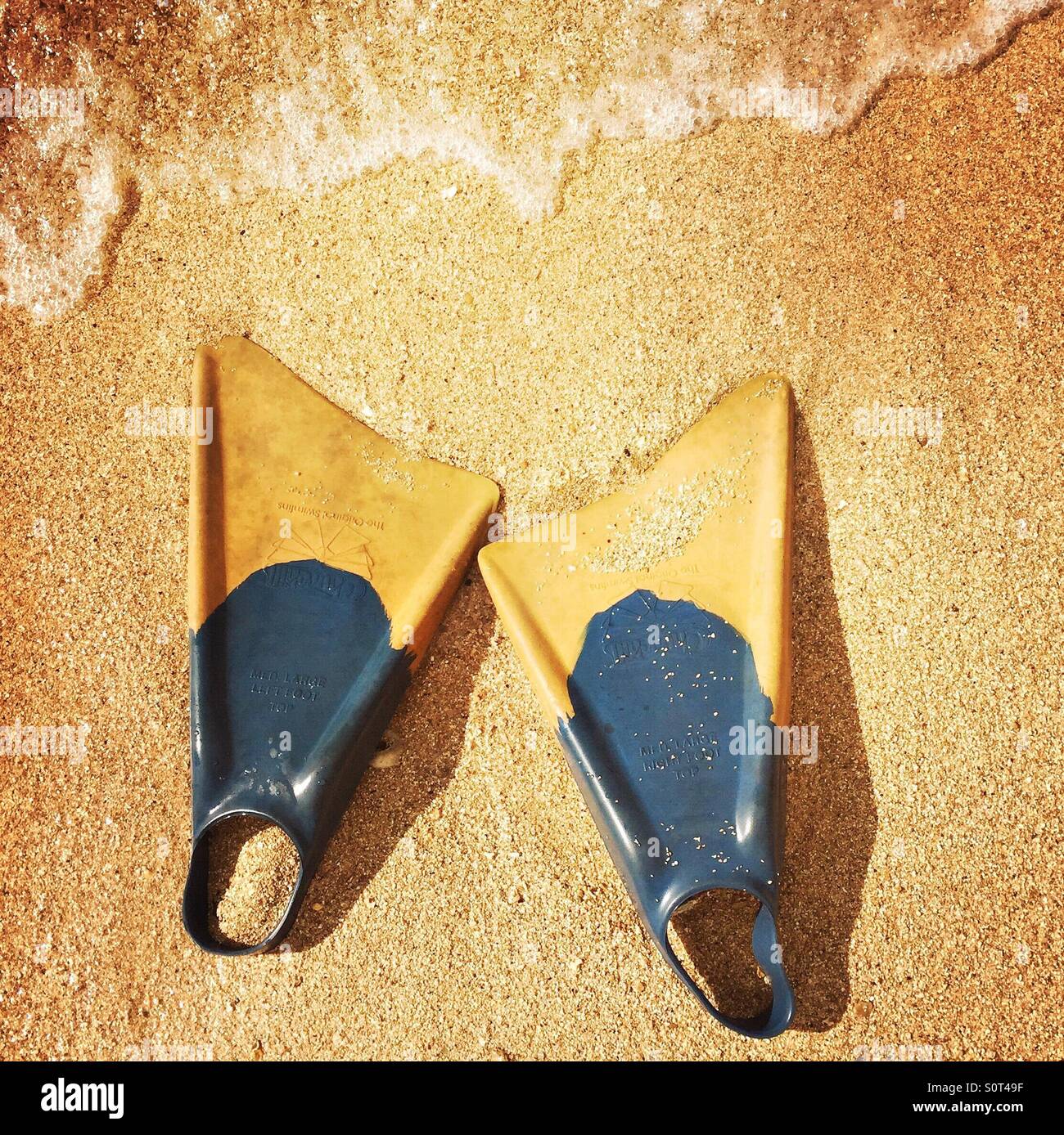 A pair of swim fins on the beach. Princeville Kauai USA Stock Photo - Alamy