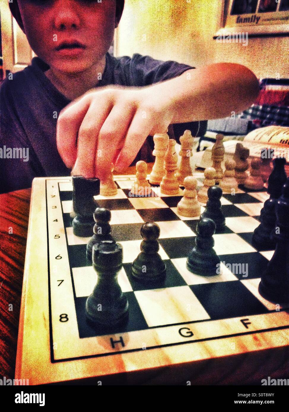 A young boy playing chess Stock Photo - Alamy