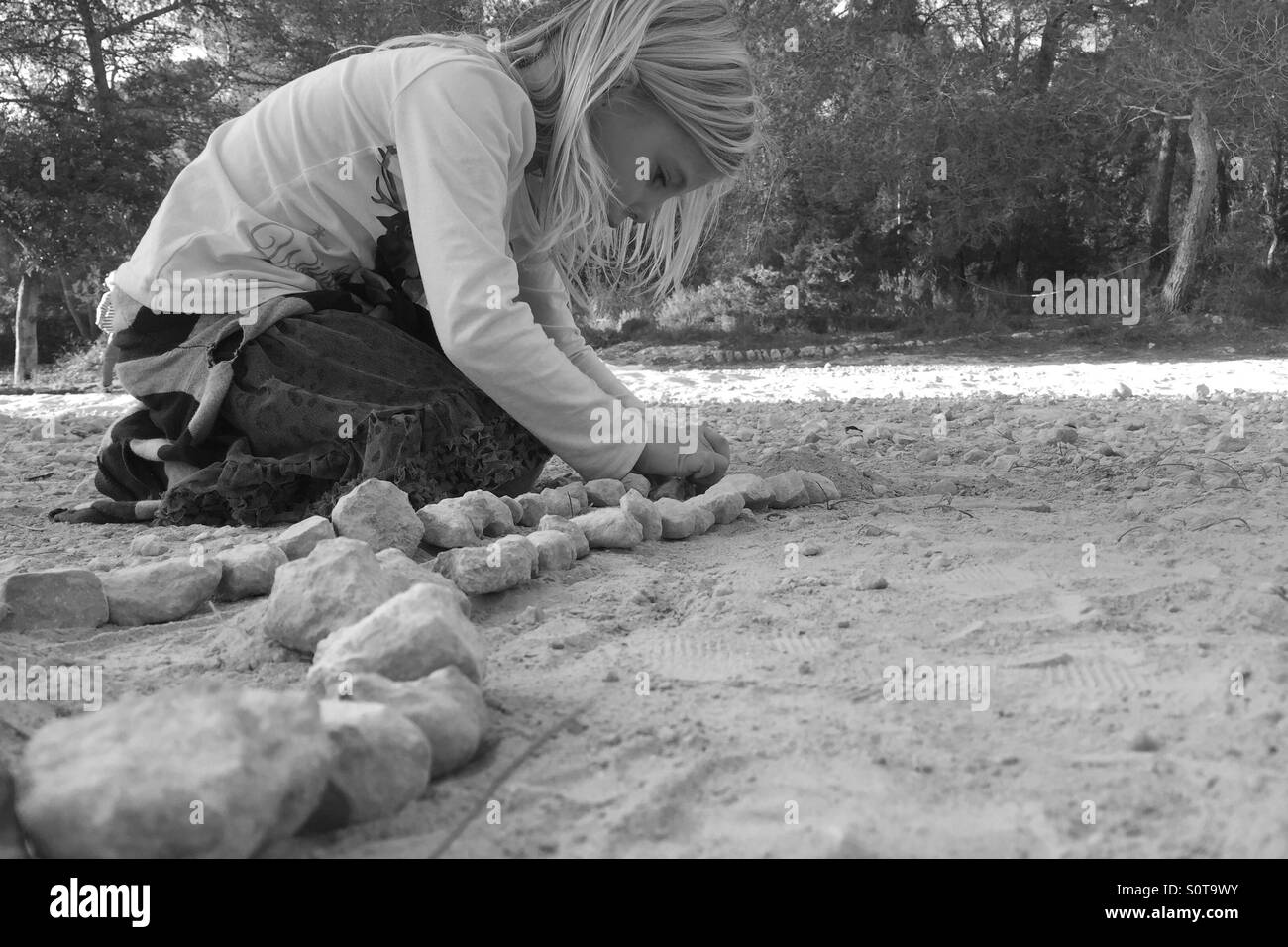 Child playing with stones hi-res stock photography and images - Alamy