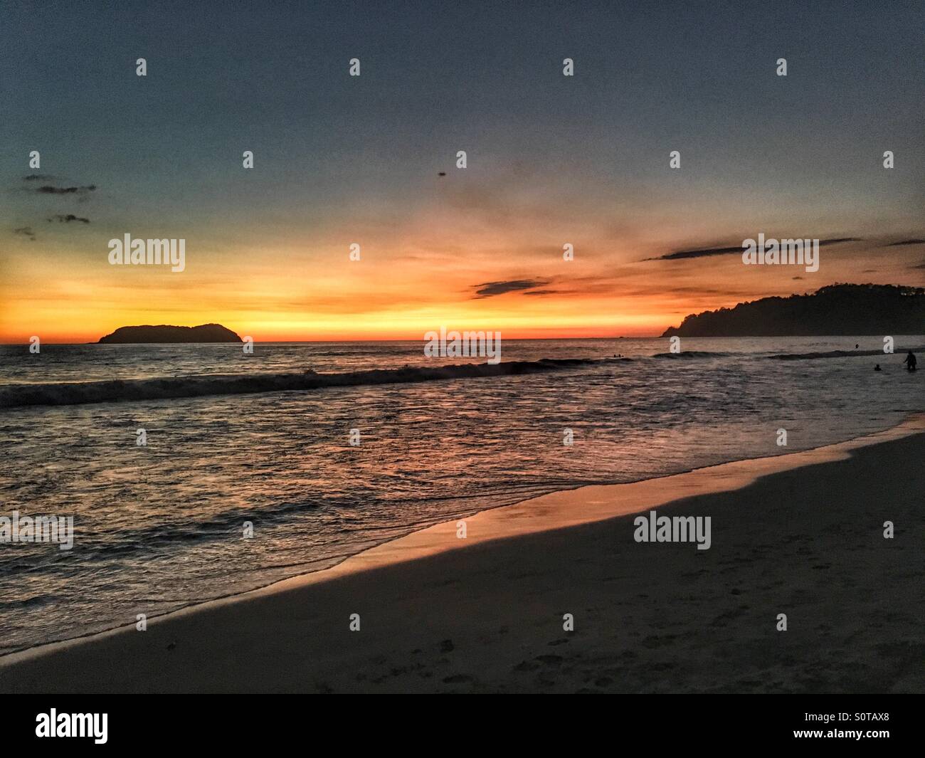 Costa Rican beach at sunset Stock Photo - Alamy