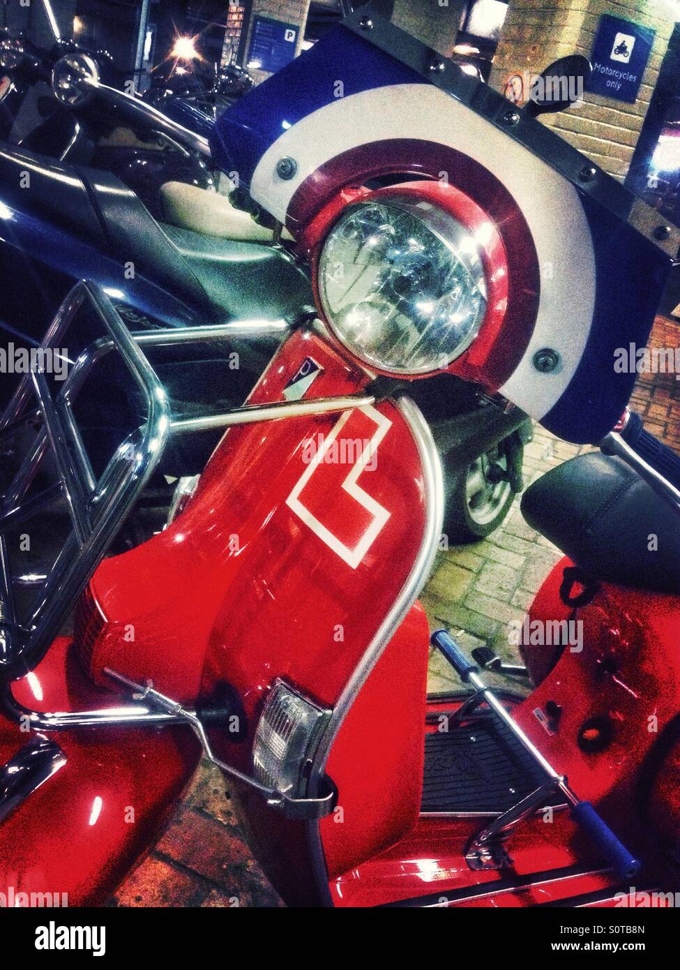 The front of a red moped scooter Stock Photo - Alamy