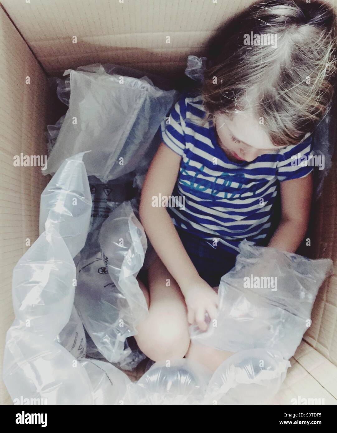 Girl in a box Stock Photo - Alamy