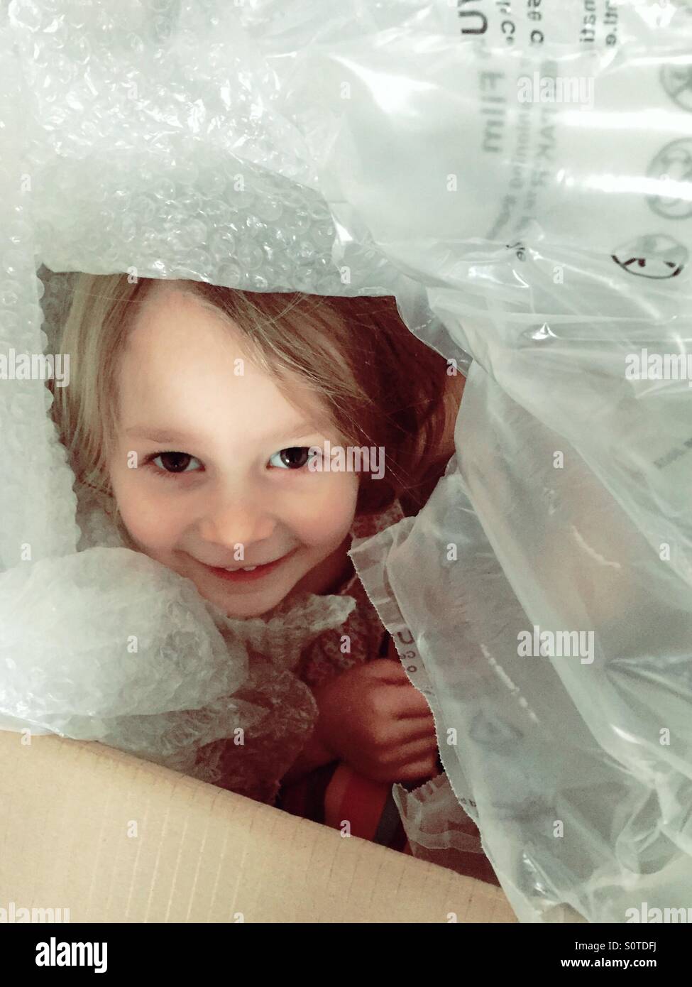 Girl in bubble rap box Stock Photo - Alamy
