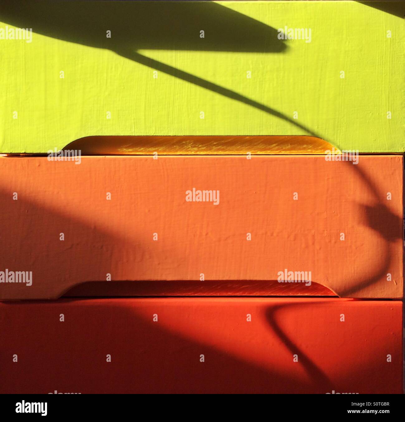 Abstract shadows on colourful, vibrant drawers Stock Photo - Alamy