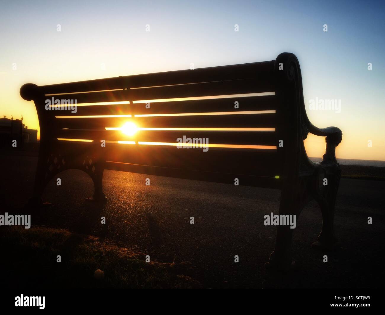 the morning sun shining through a wooden bench Stock Photo - Alamy