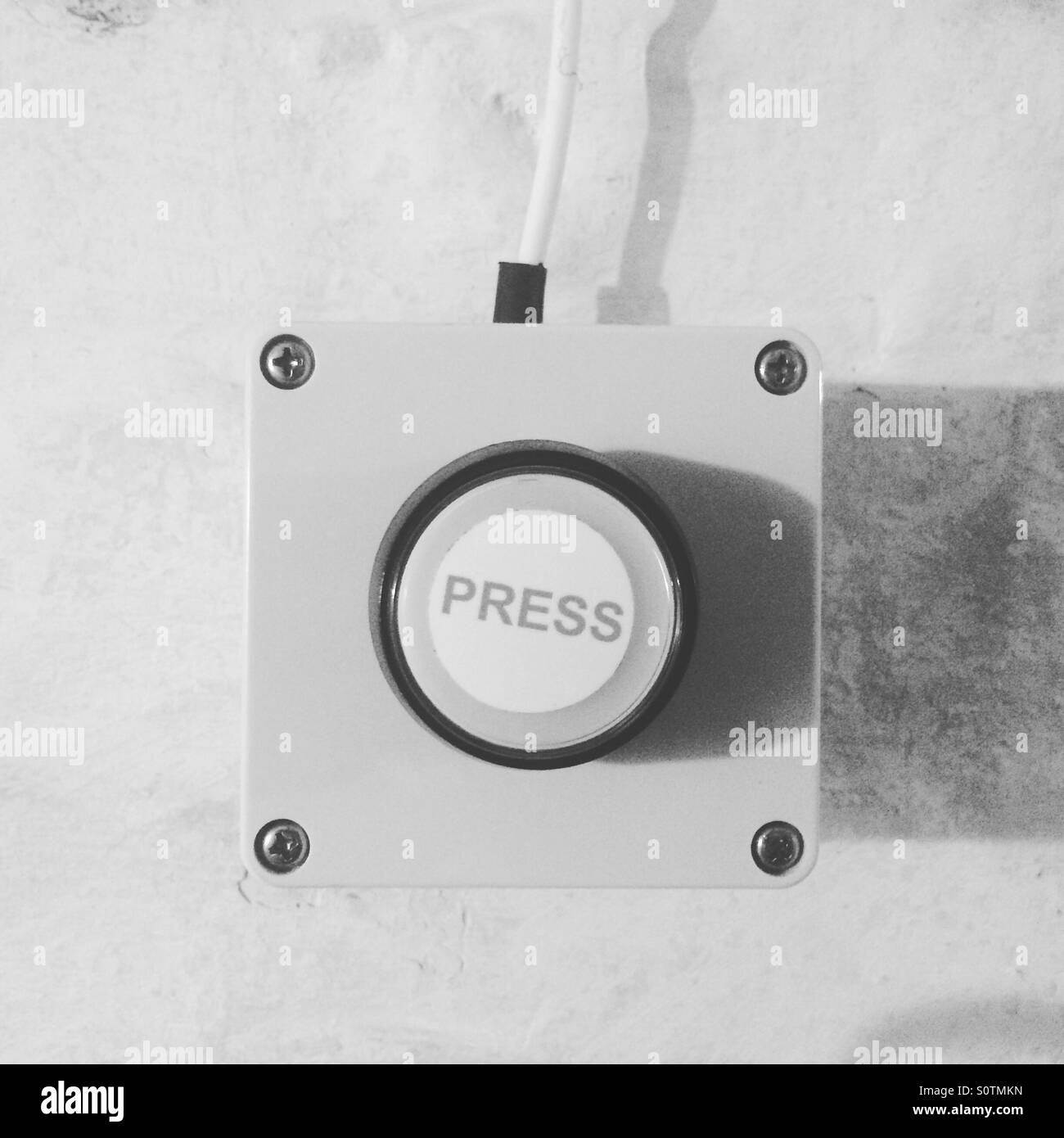 Press button on a wall Stock Photo - Alamy