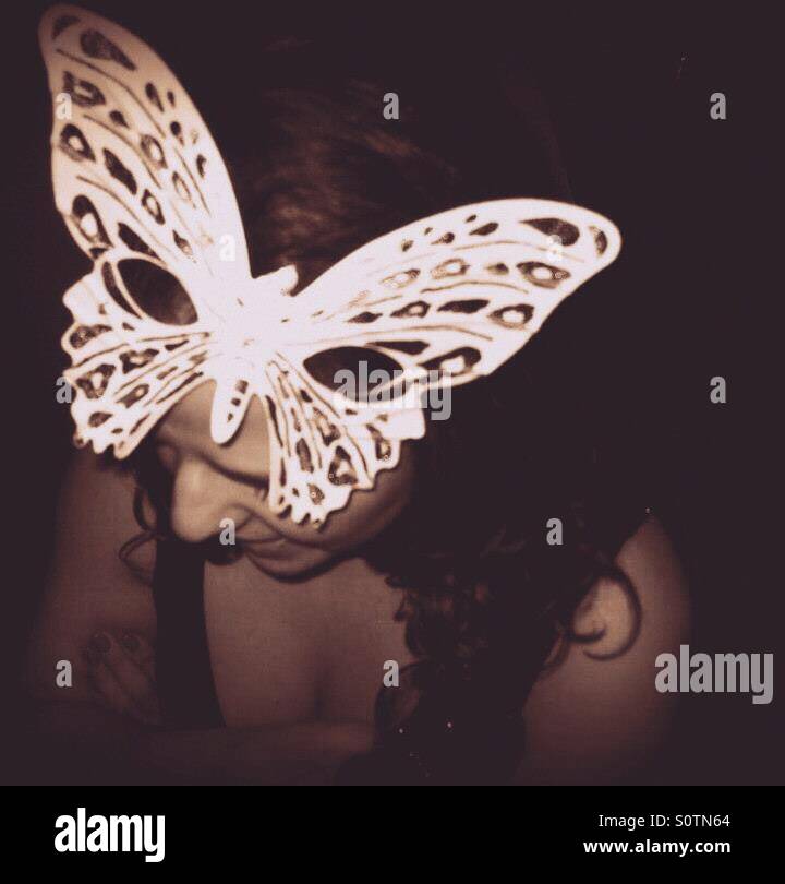 Woman wearing butterfly mask hi-res stock photography and images - Alamy