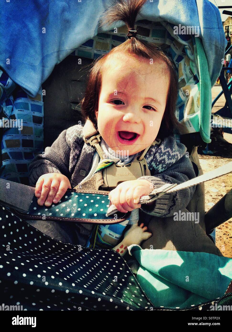 A young happy boy in a pushchair Stock Photo - Alamy