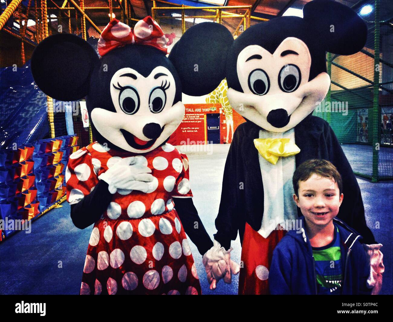 A young boy with Mickey and Monnie Mouse Stock Photo - Alamy