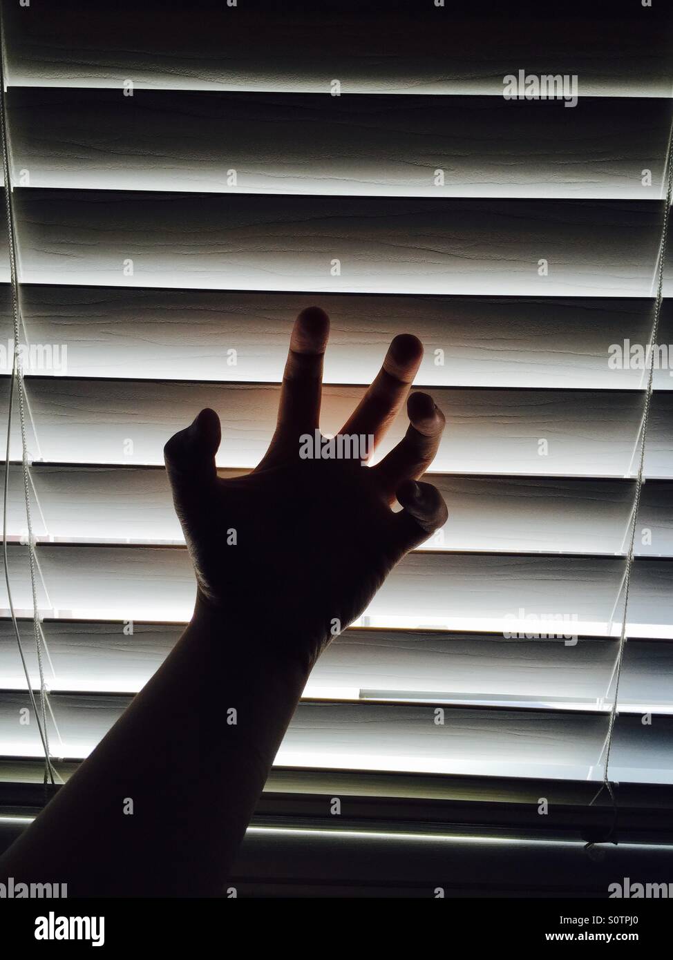 A Hand and Blinds Stock Photo - Alamy
