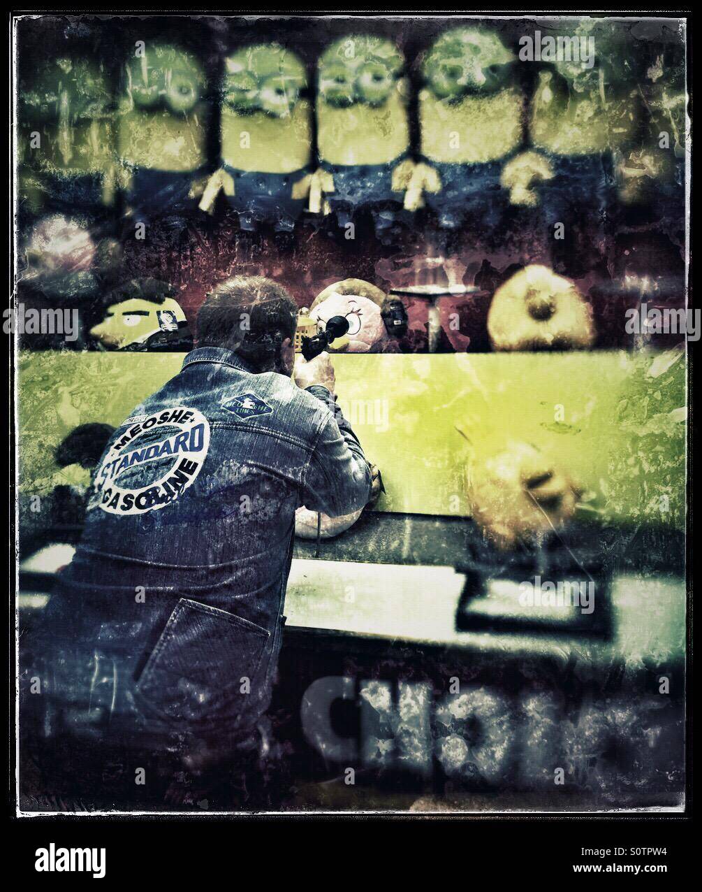 Man playing a carnival game hi-res stock photography and images - Alamy