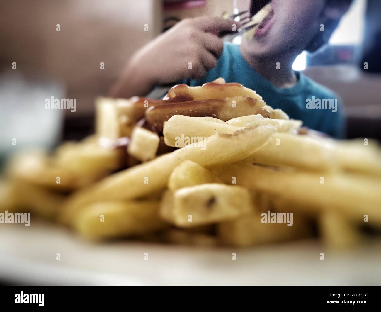 Child eating chips hi-res stock photography and images - Alamy