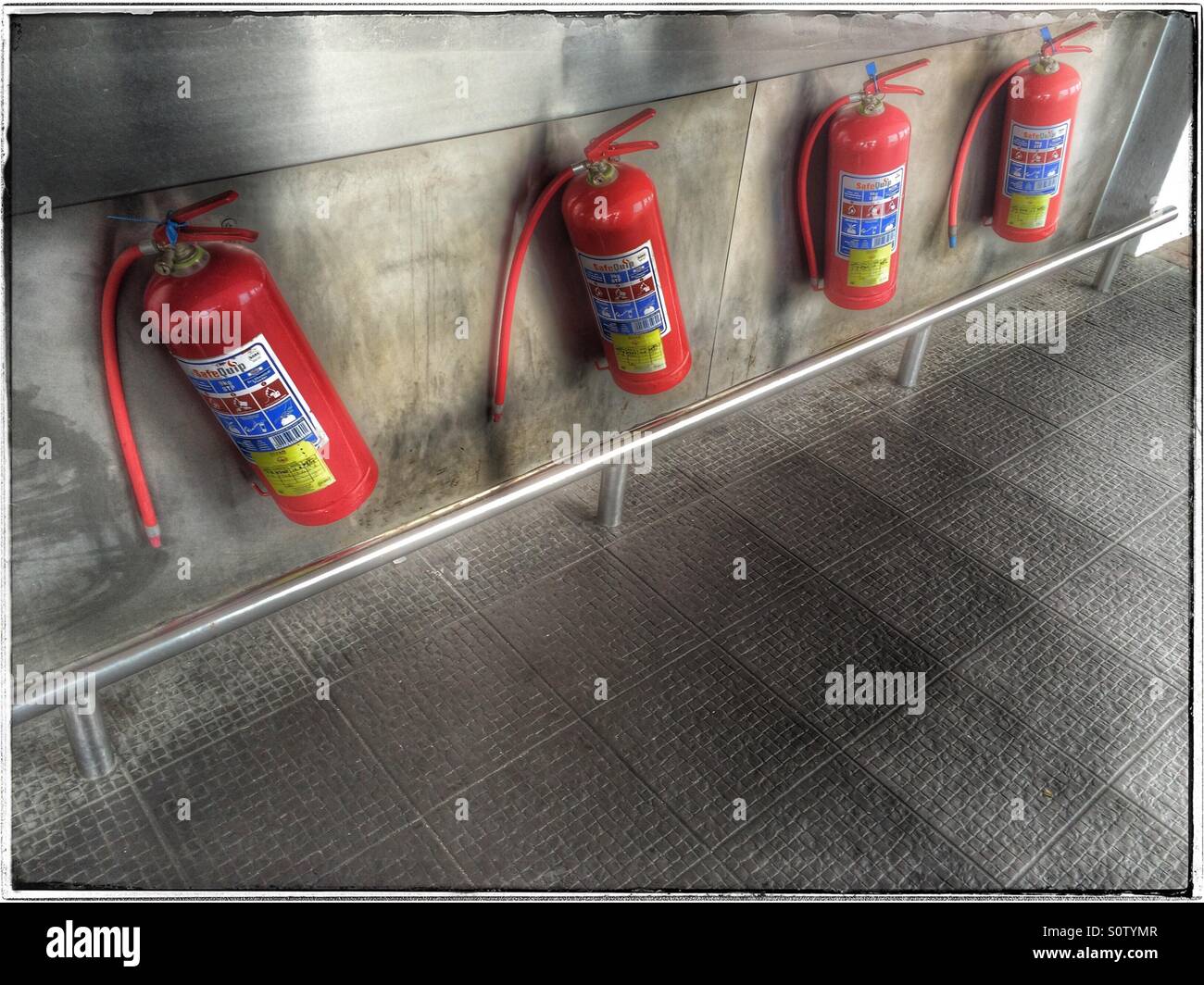 Row of fire extinguishers Stock Photo - Alamy
