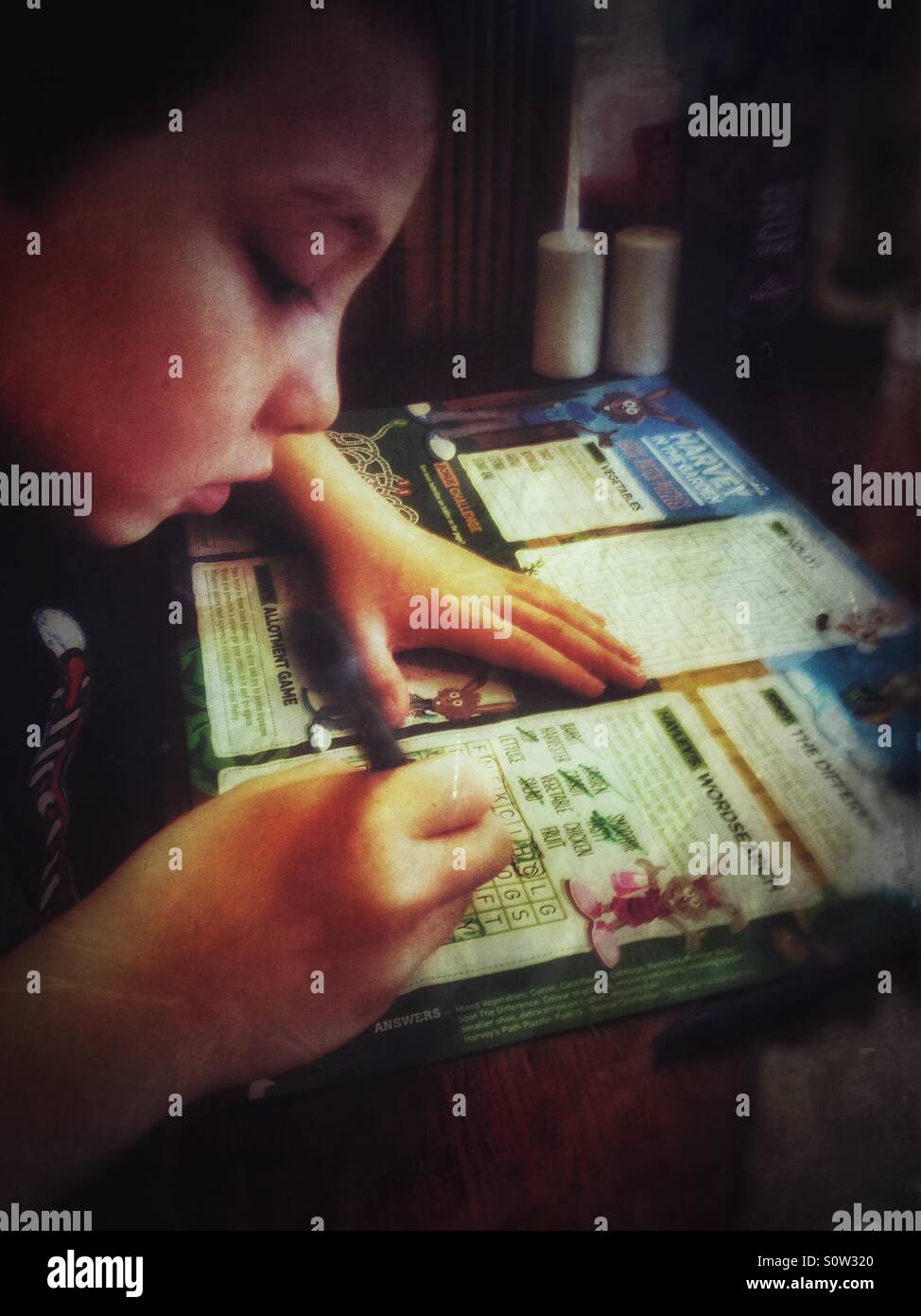 A boy doing a word search in s restaurant Stock Photo - Alamy