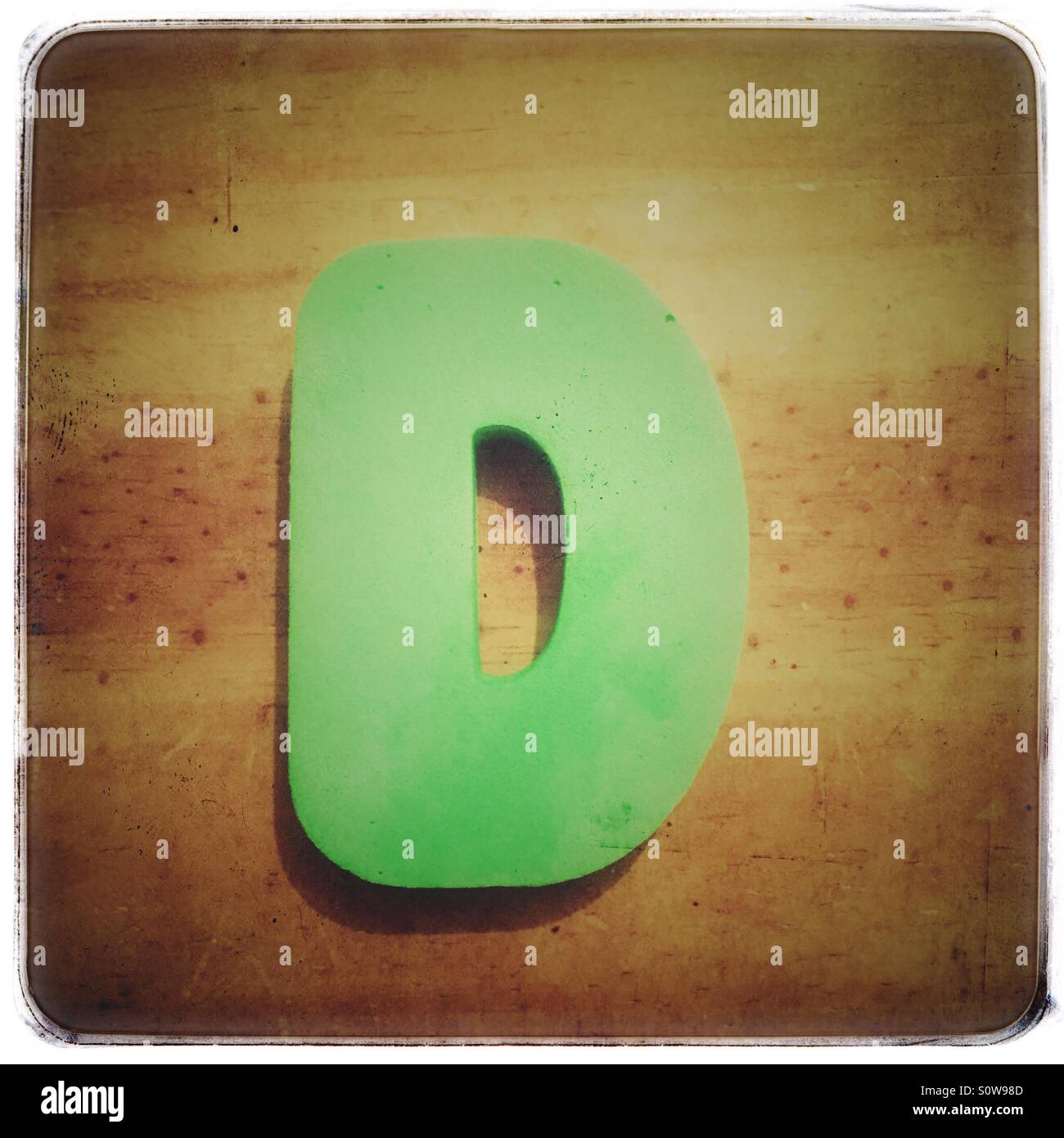 Textured foam letter D on a grungy wood background Stock Photo - Alamy