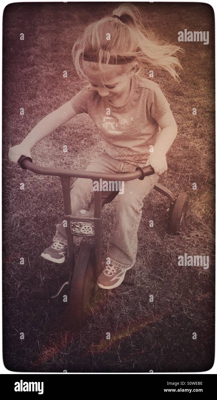 Girl riding tricycle hi-res stock photography and images - Alamy