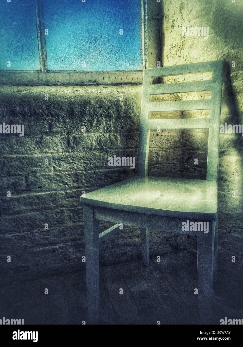 Wooden chair by the window Stock Photo - Alamy