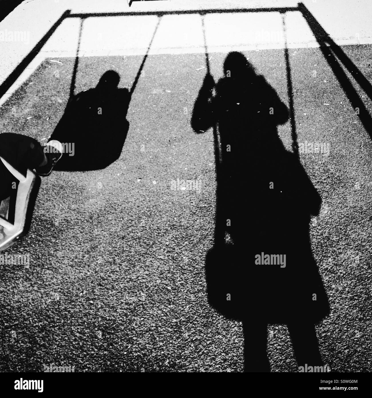 Shadow child on swing hi-res stock photography and images - Alamy