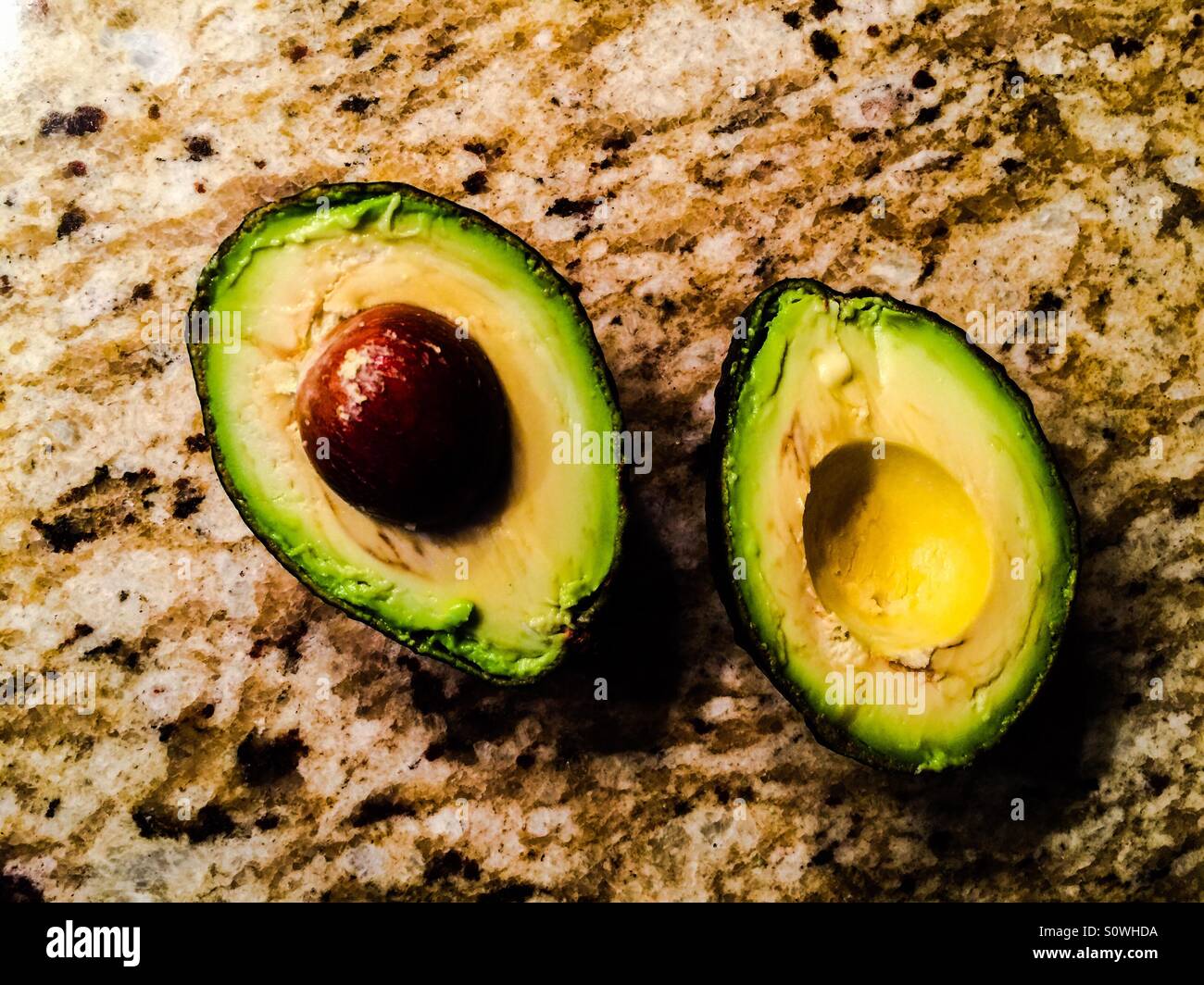 Avocado on granite counter Stock Photo - Alamy