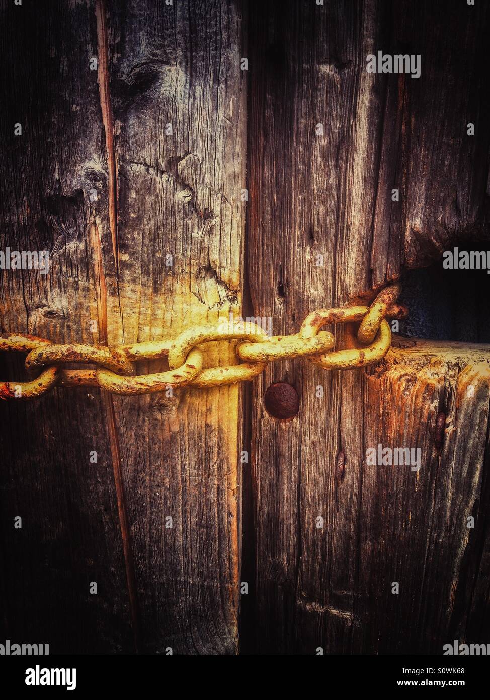 Wooden doors closed with a rusty chain Stock Photo - Alamy