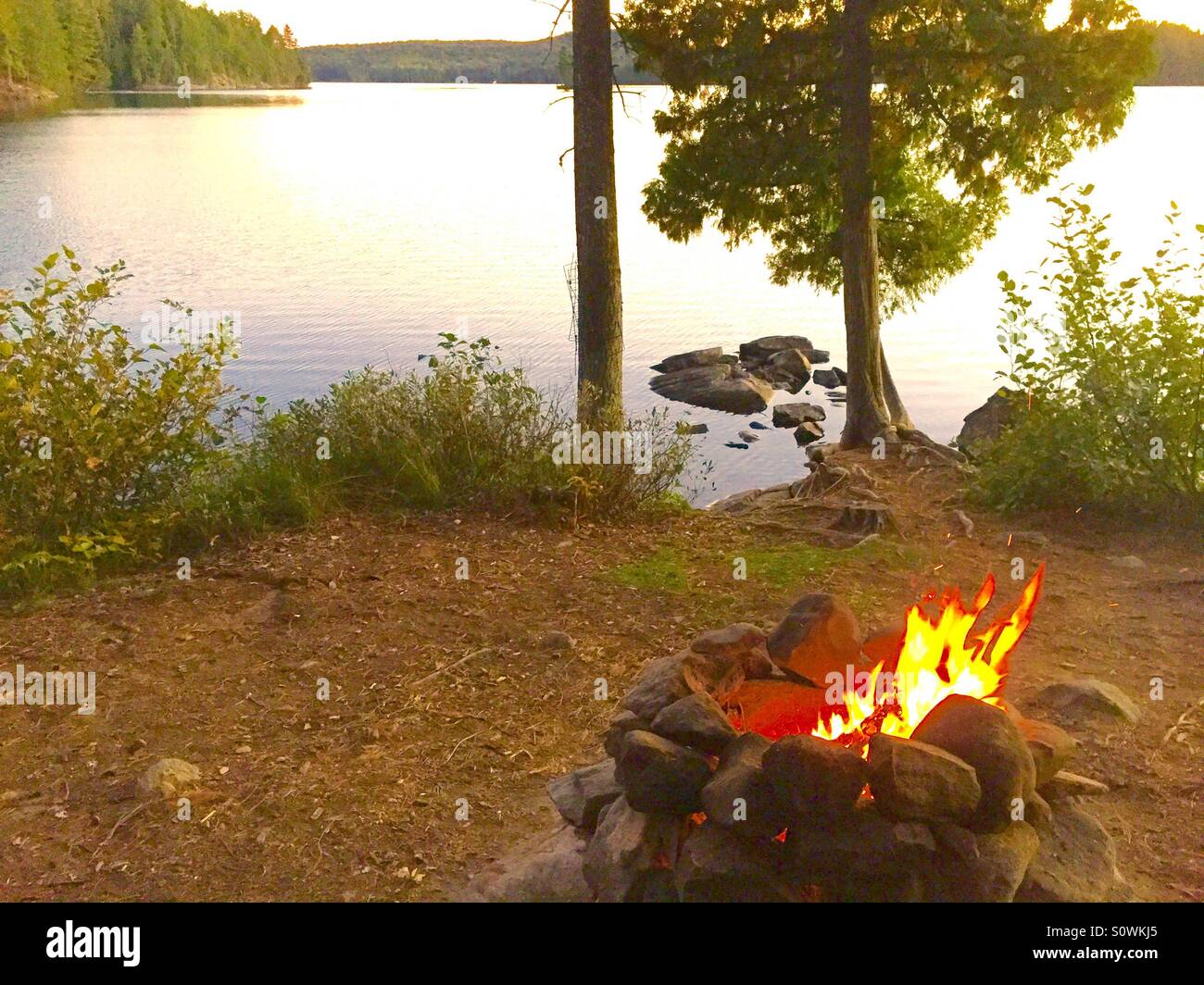 Campfire At Lakeshore Evening Stock Photo - Alamy
