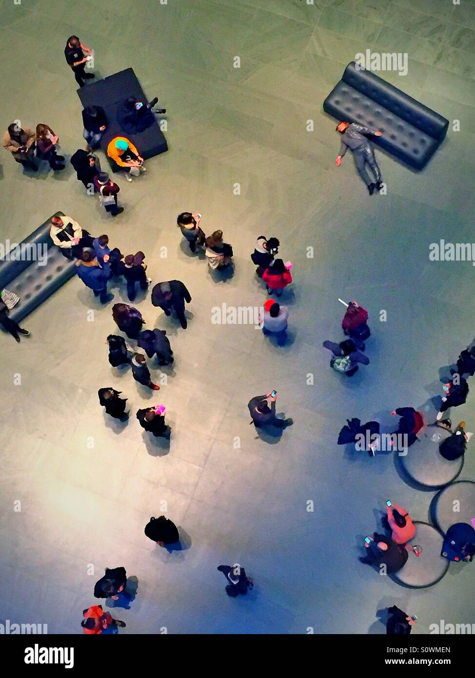 People standing in museum atrium with inter-active art exhibit shot ...