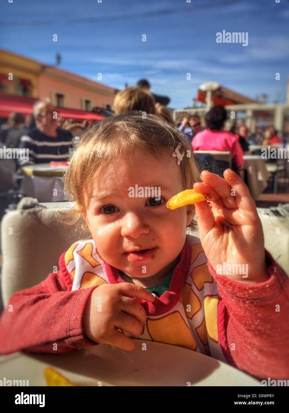Toddler eating French fries Stock Photo - Alamy