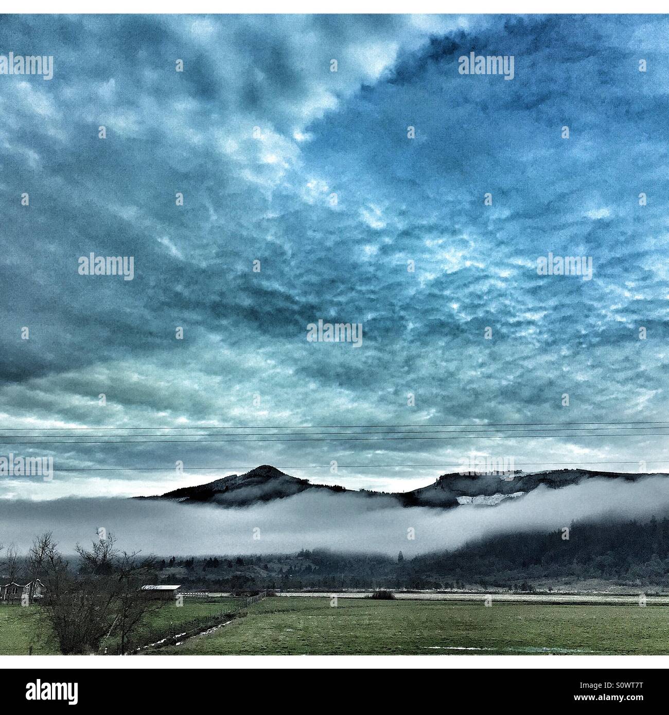 Dramatic winter sky over rural highway and hills Stock Photo - Alamy