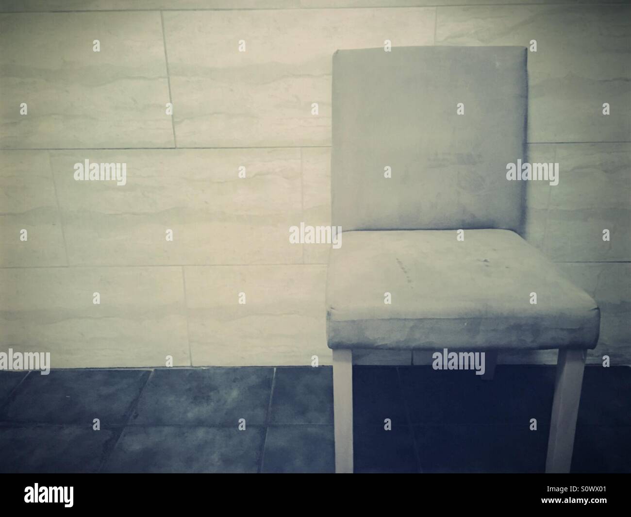Chair against the wall Stock Photo - Alamy