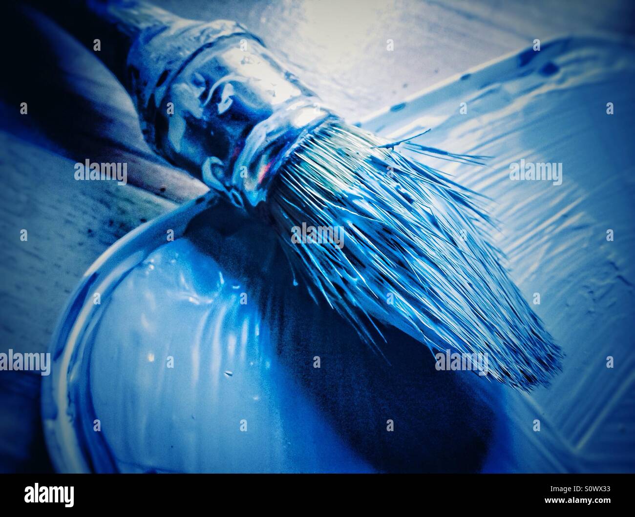 Paint brush of blue paint Stock Photo - Alamy