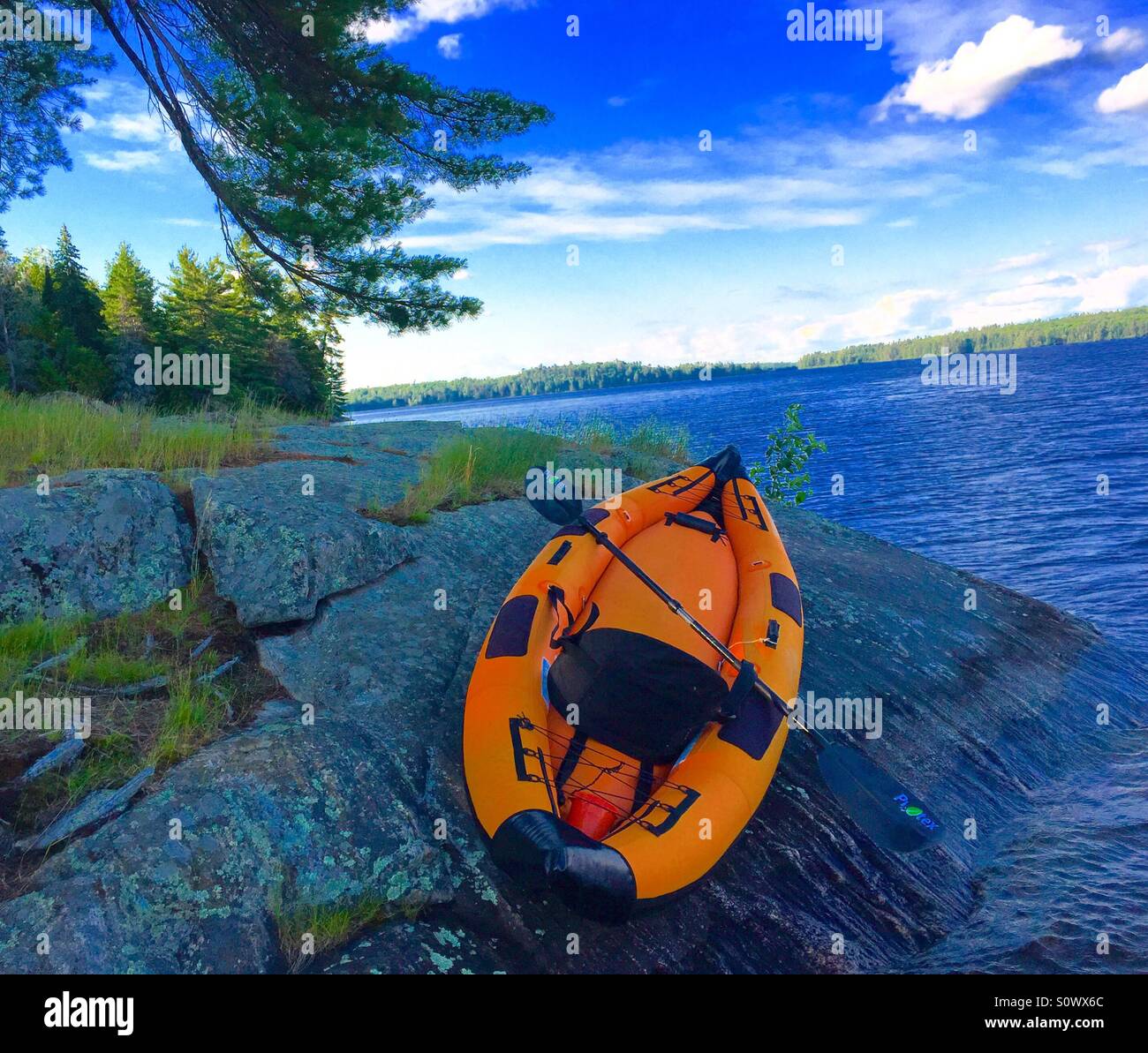 Inflatable Kayak At Rock Outcrop Lakeshore Stock Photo - Alamy