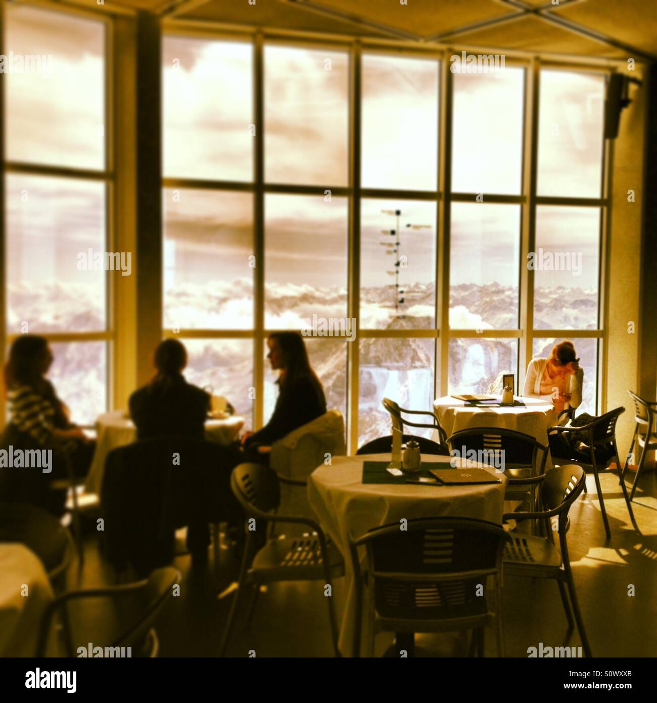 Inside restaurant with the snowed mountain view through the big glass ...