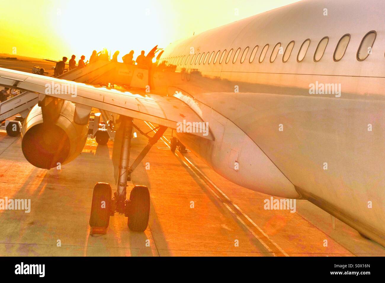 Passengers boarding airplane Stock Photo - Alamy