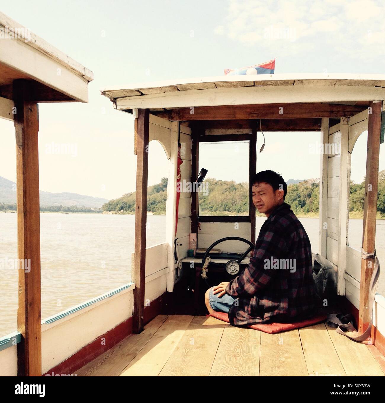 Boat driver Mekong Laos Stock Photo - Alamy