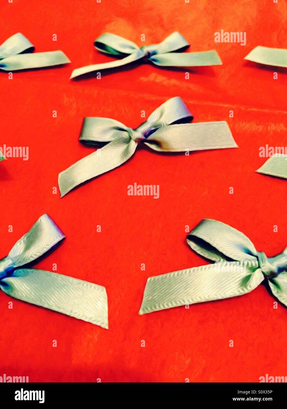 Blue ribbon tied in bows on a red background Stock Photo - Alamy