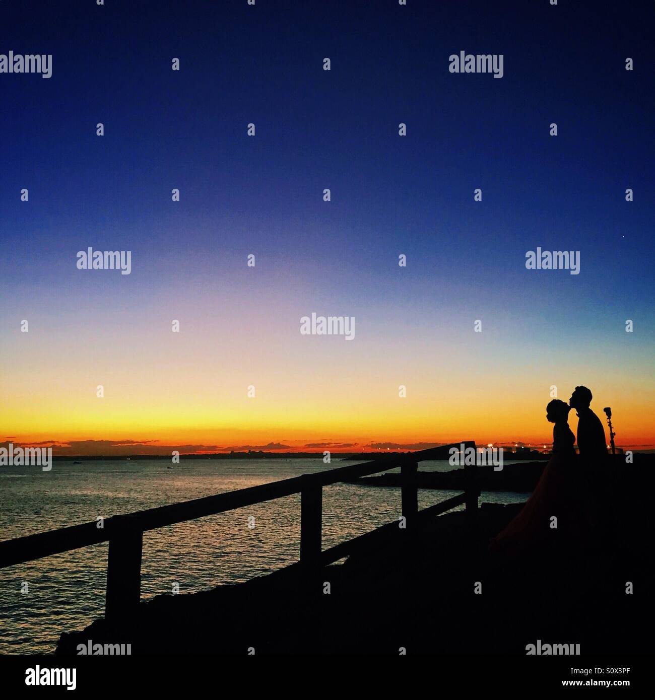 Couple kissing in the sunset at sea hi-res stock photography and images ...
