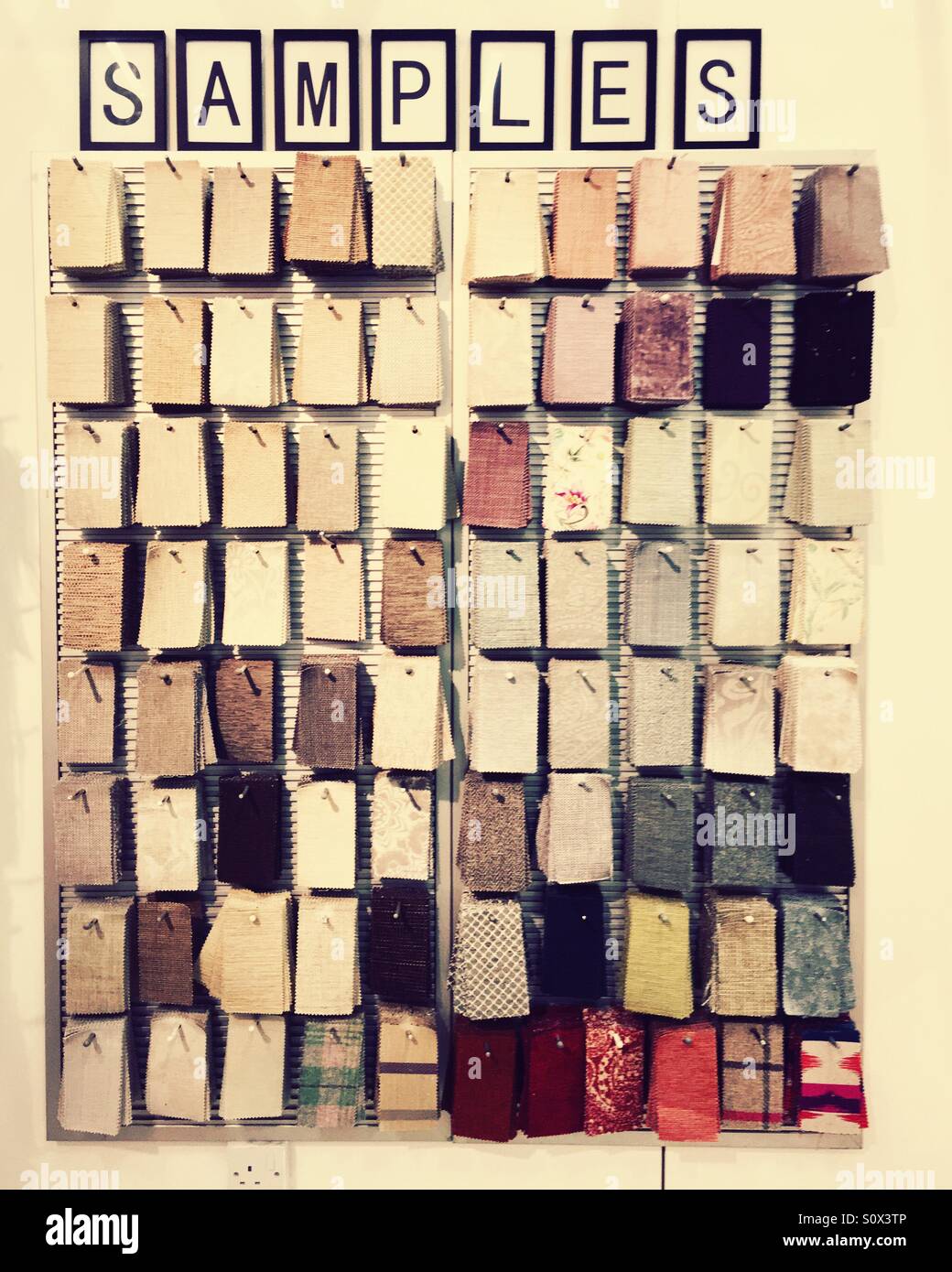 Fabric samples hanging on a wall Stock Photo - Alamy