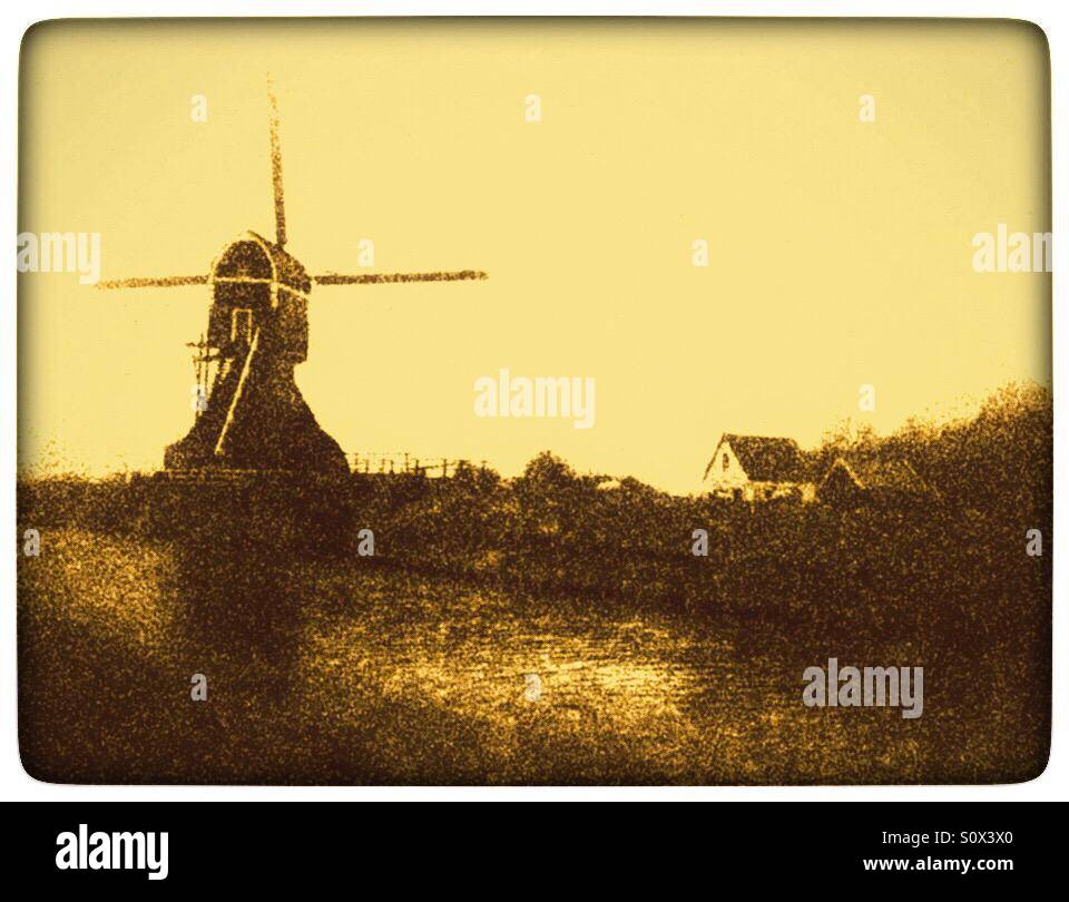 Windmill on a river in Holland Stock Photo - Alamy