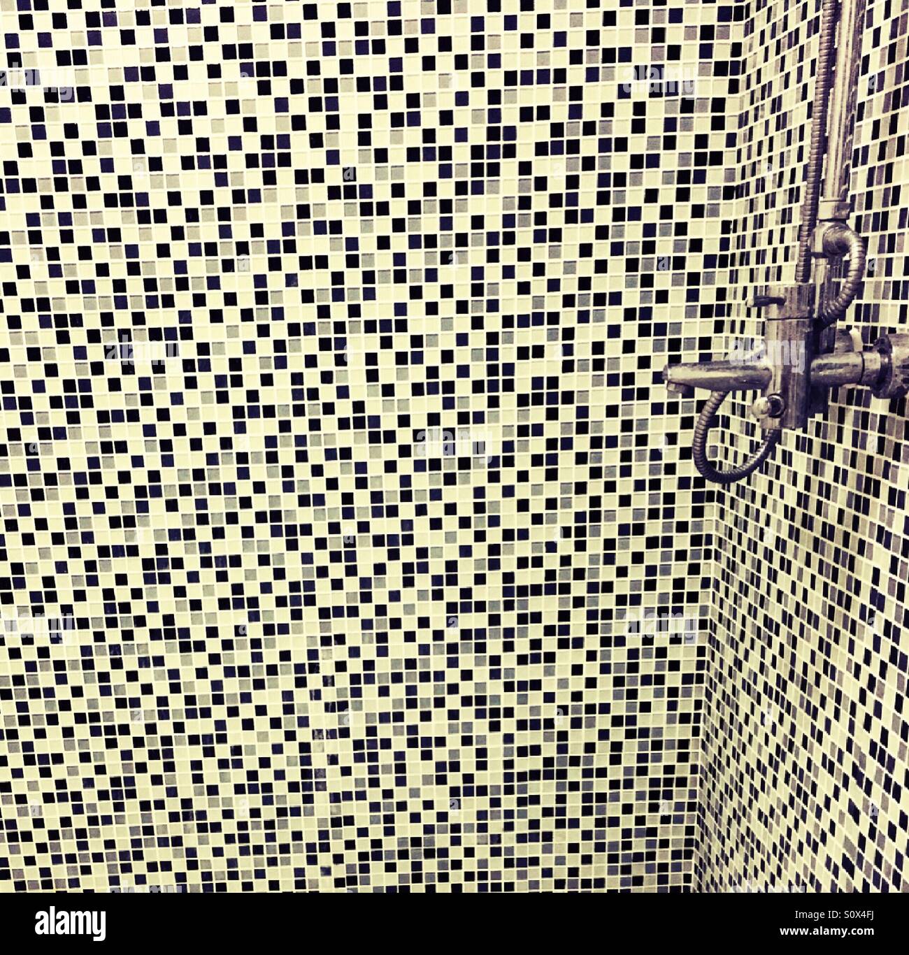 Shower tap on the mosaic wall of bathroom Stock Photo - Alamy