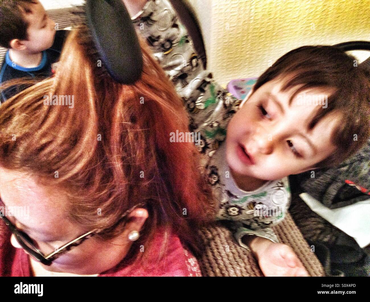 A young boy brushing his Mummy's hair Stock Photo - Alamy