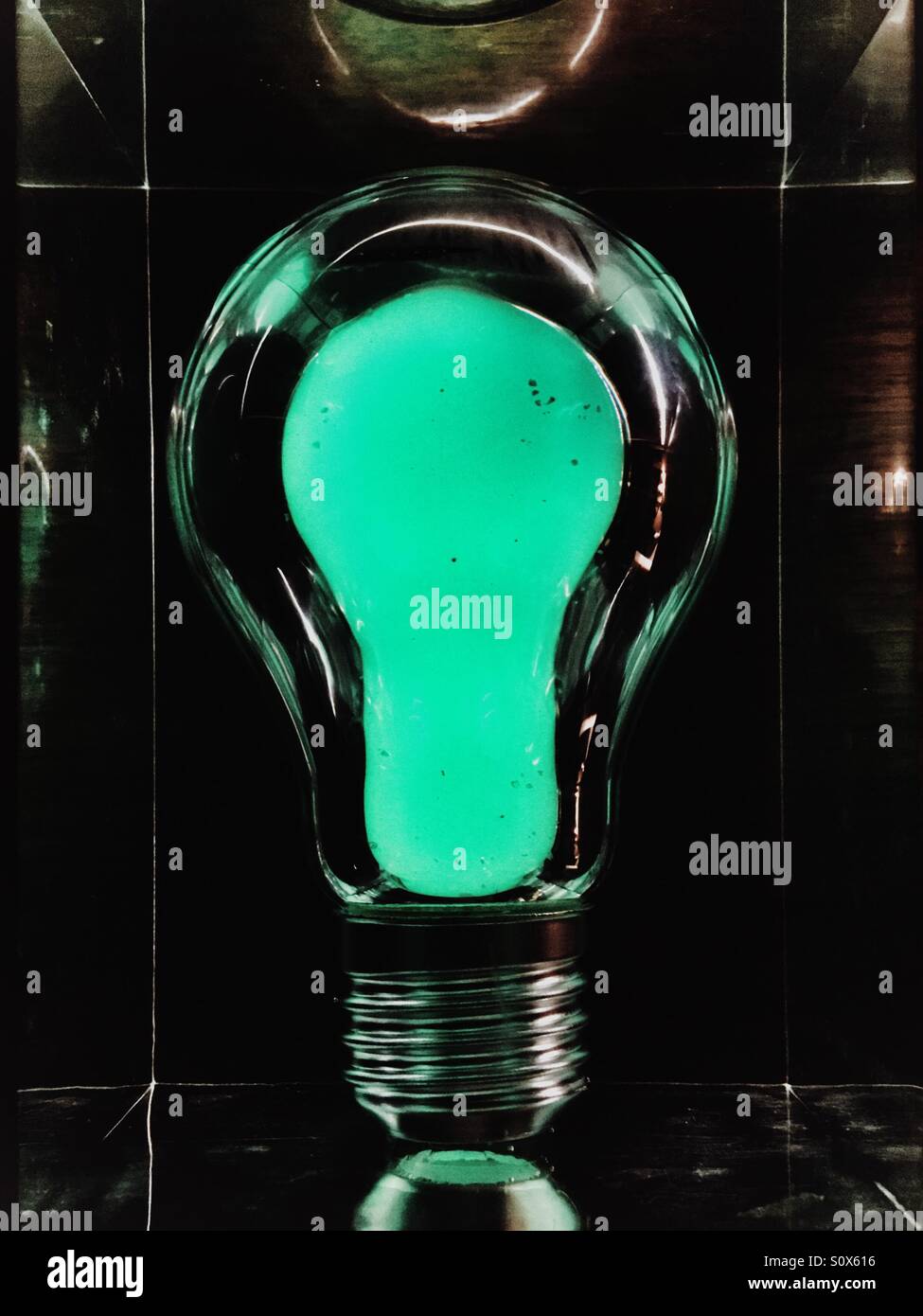 Glowing light bulb encased in acrylic Stock Photo - Alamy