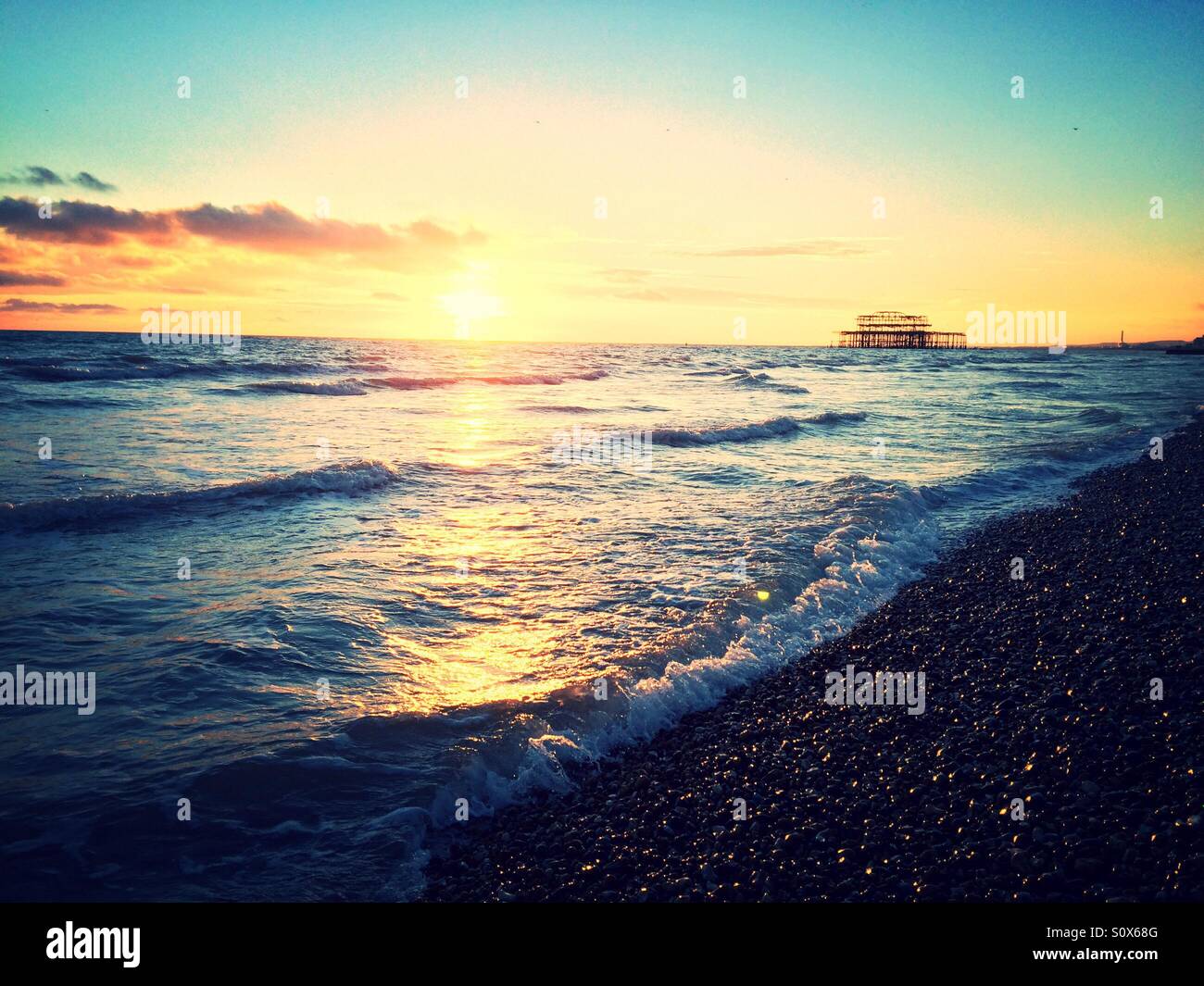 Brighton old pier at sunset Stock Photo - Alamy