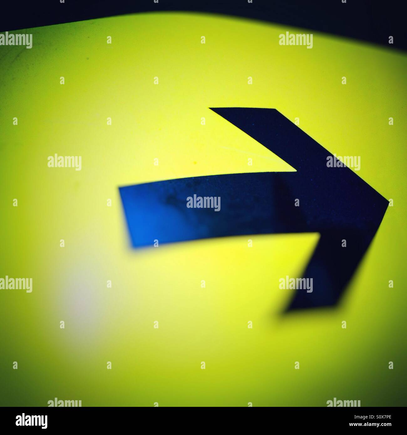 Right arrow sign on yellow background Stock Photo - Alamy