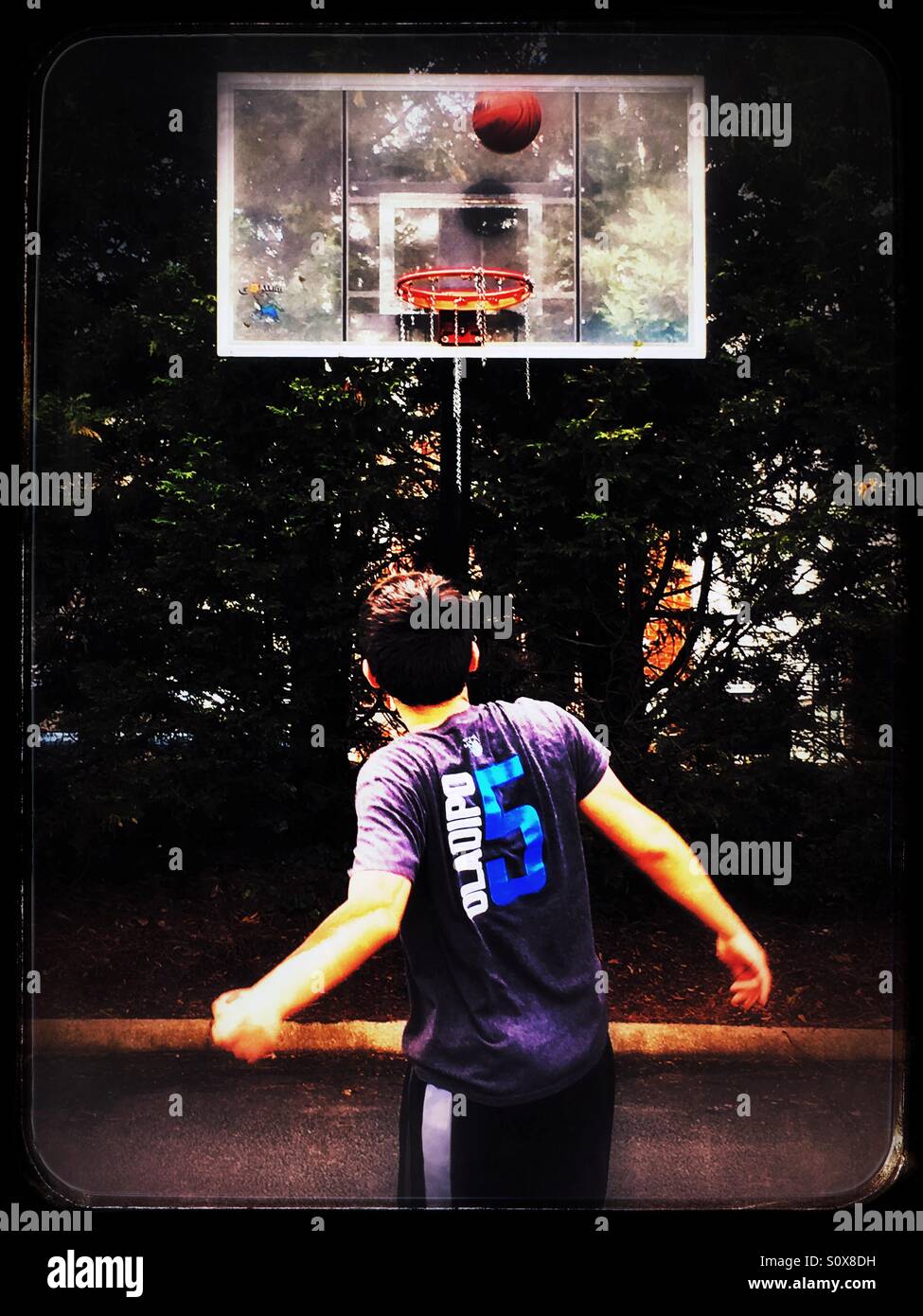 Boy shooting basketball hi-res stock photography and images - Alamy