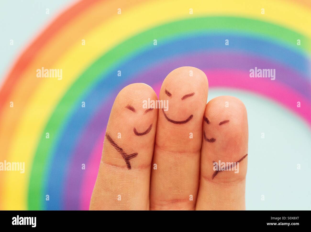 A group of happy and smiling finger character friends with a rainbow in ...